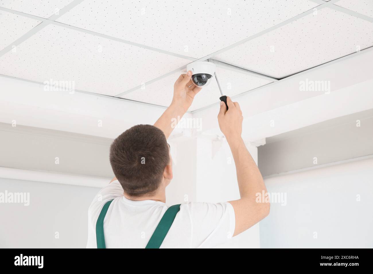 Back view man installing camera hi-res stock photography and images - Alamy