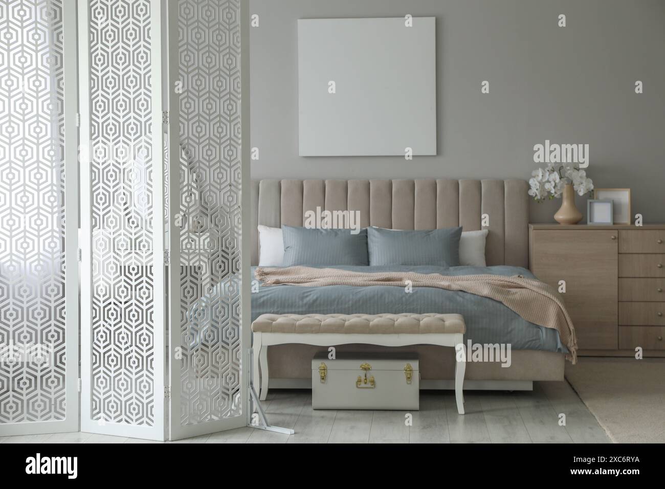 Folding screen, mirror and comfortable bed in bedroom. Interior design ...