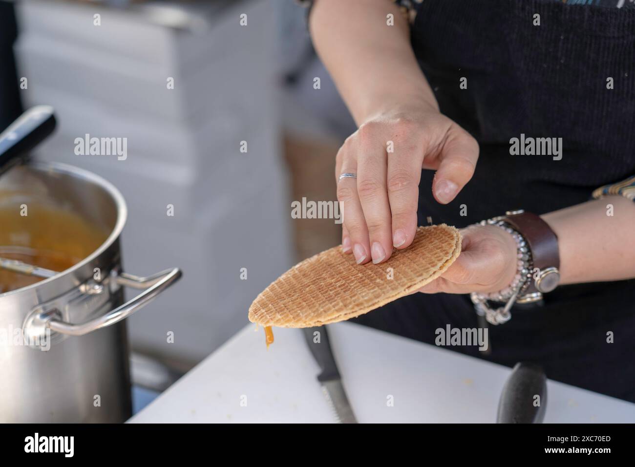 person at local markets in The Netherlands making dutch waffles ...