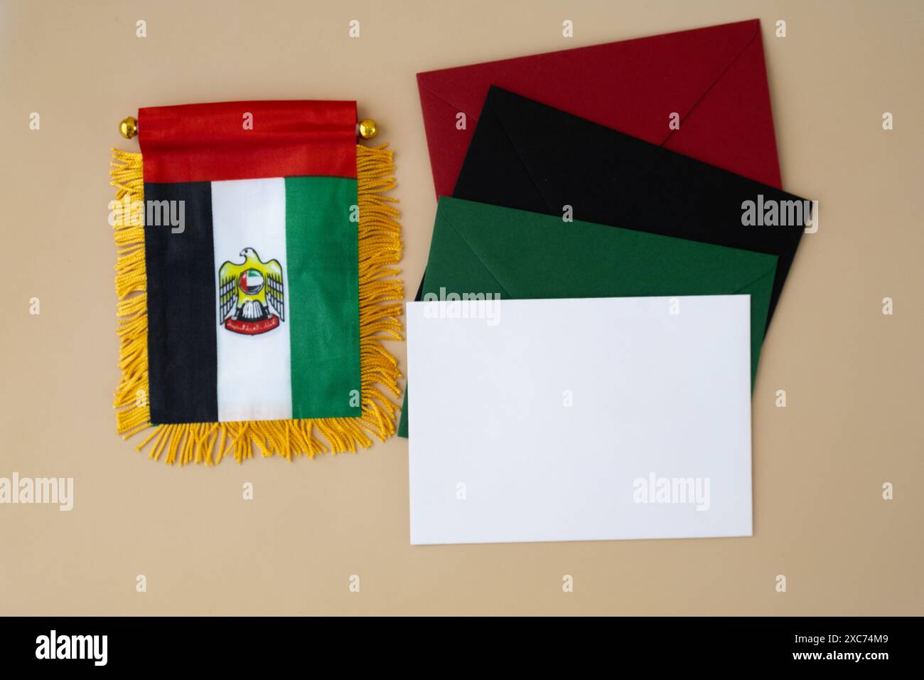 Small flag of UAE on beige background with colorful envelopes. Copy ...
