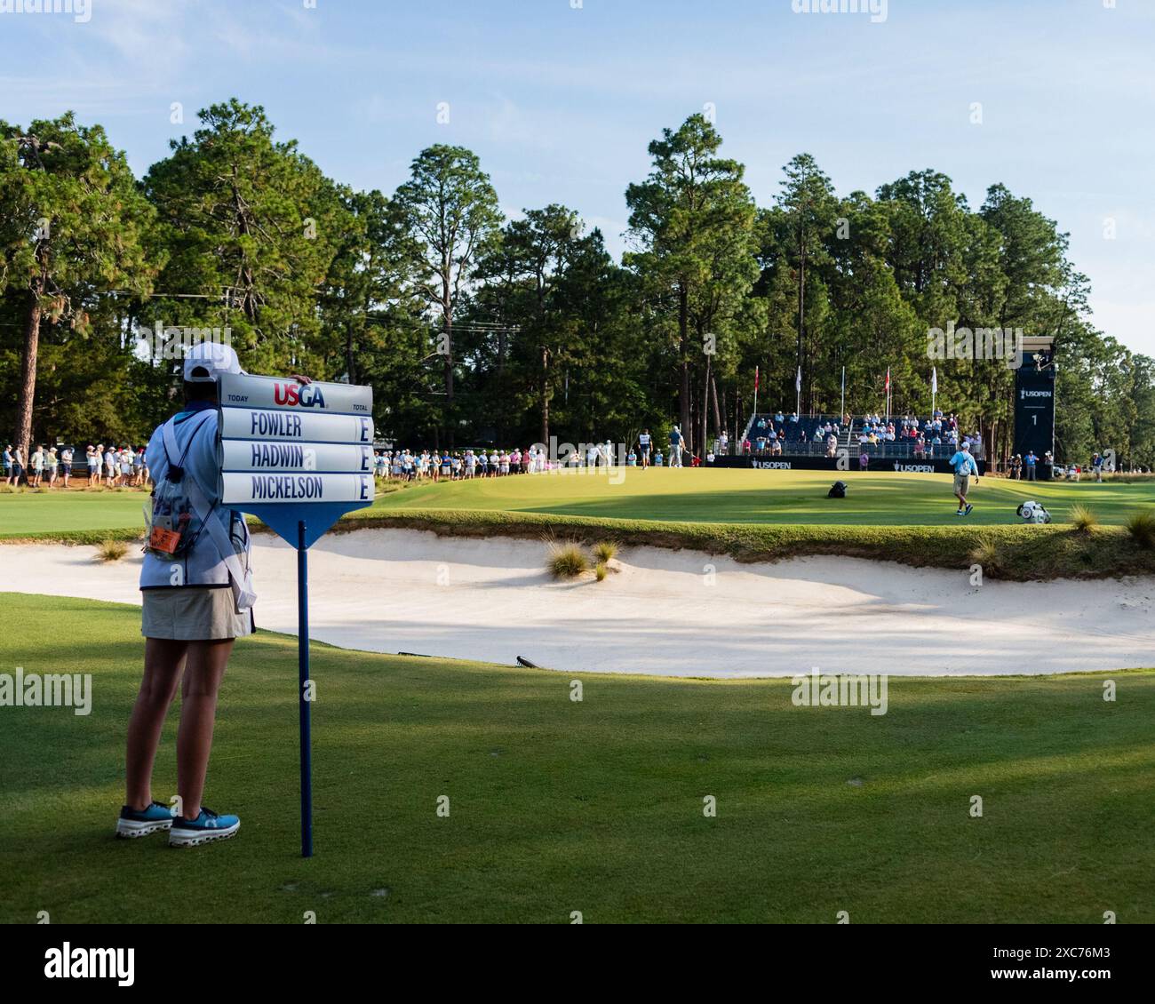 Pinehurst, North Carolina, USA. 13th June, 2024. A standard bearer waits on the second tee for ...