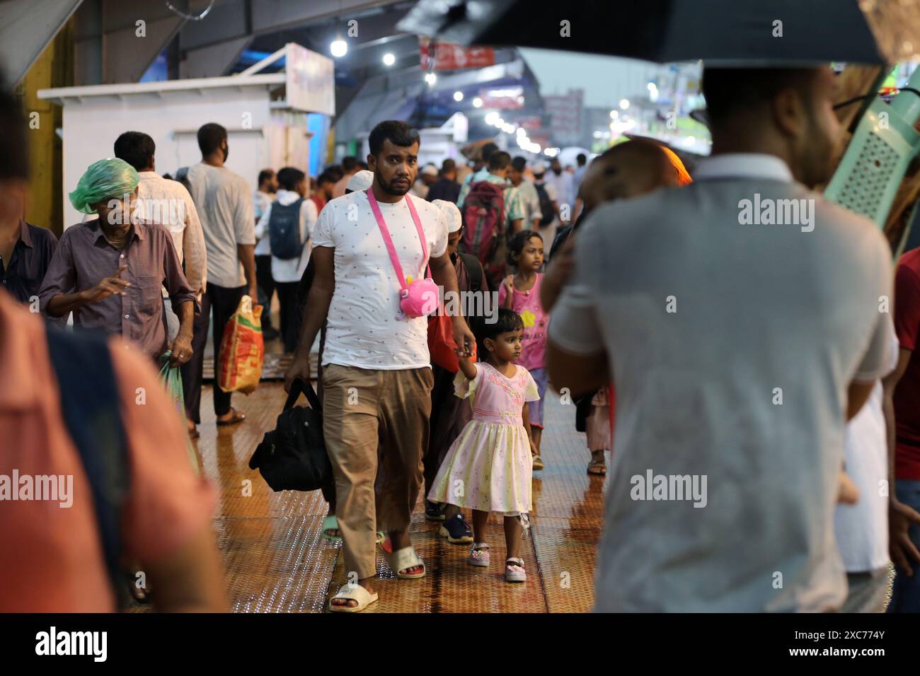 Dhaka. 15th June, 2024. Passengers are seen at a dock on trips back to their hometowns ahead of ...