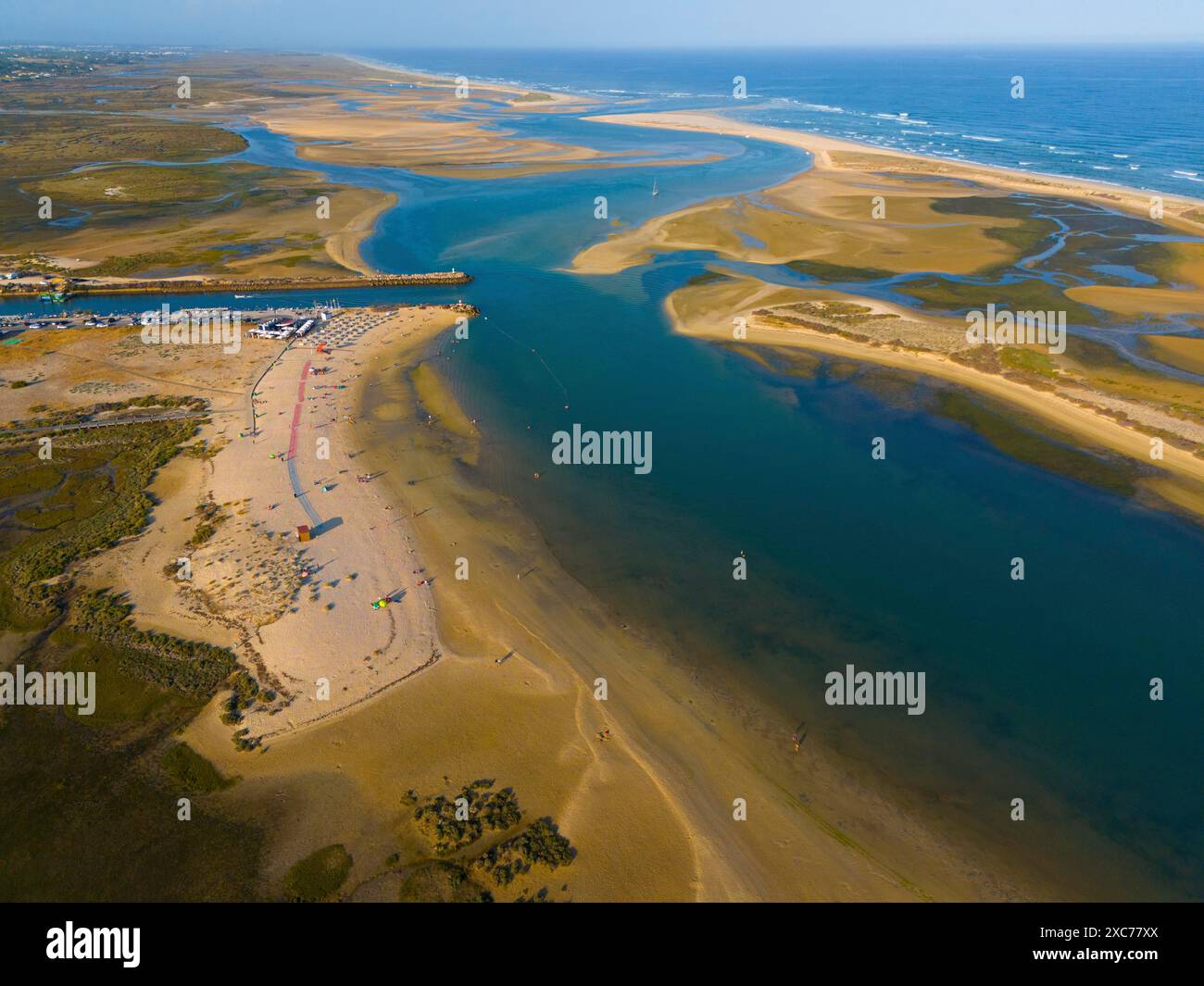 Aerial view of an extensive coastal area with sandbanks and buildings ...
