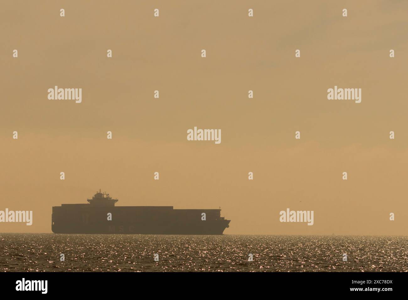 Container ship on the sea at sunrise heading to the port of Felixstowe ...