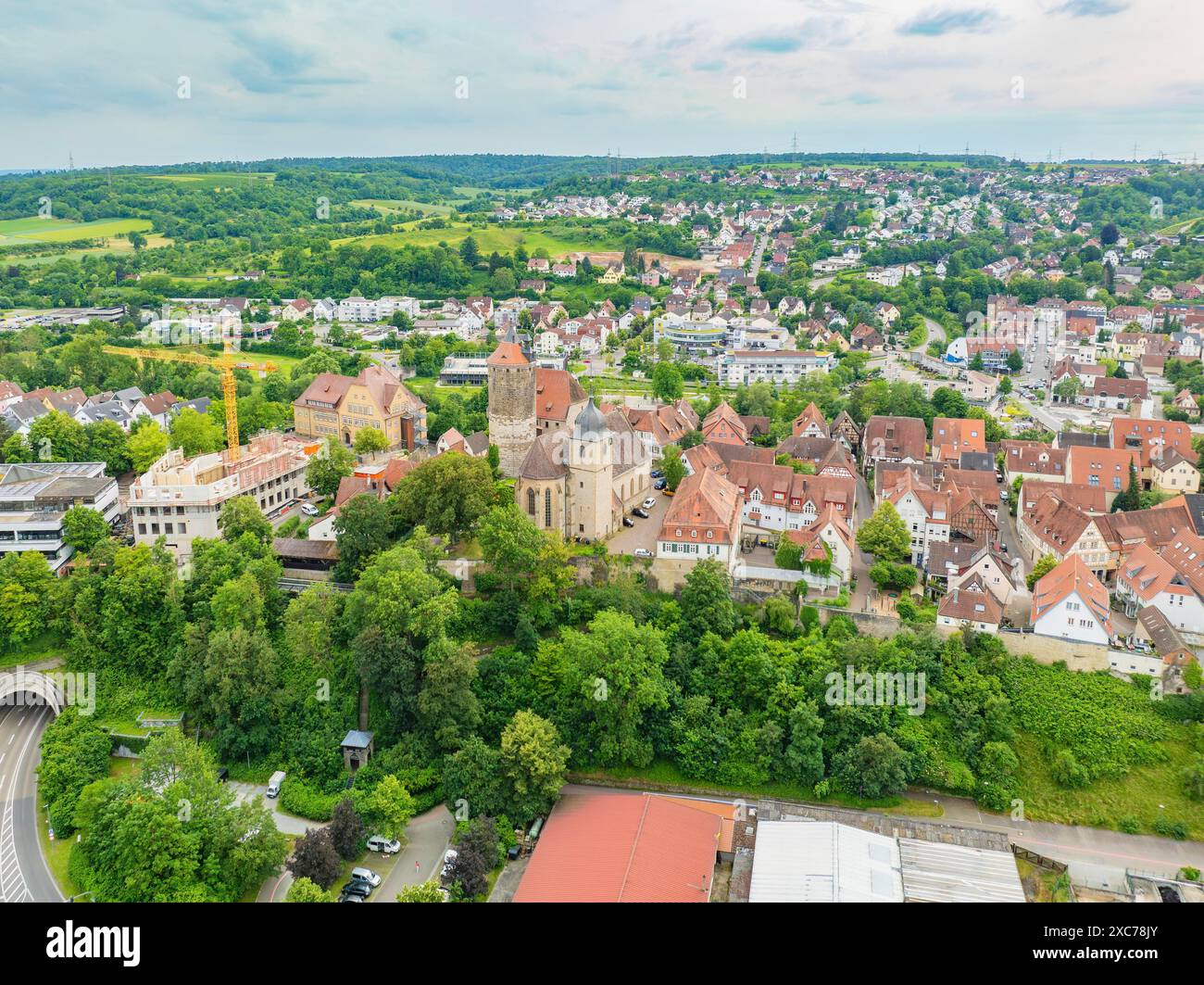 View of a town with historic buildings and a church surrounded by green ...