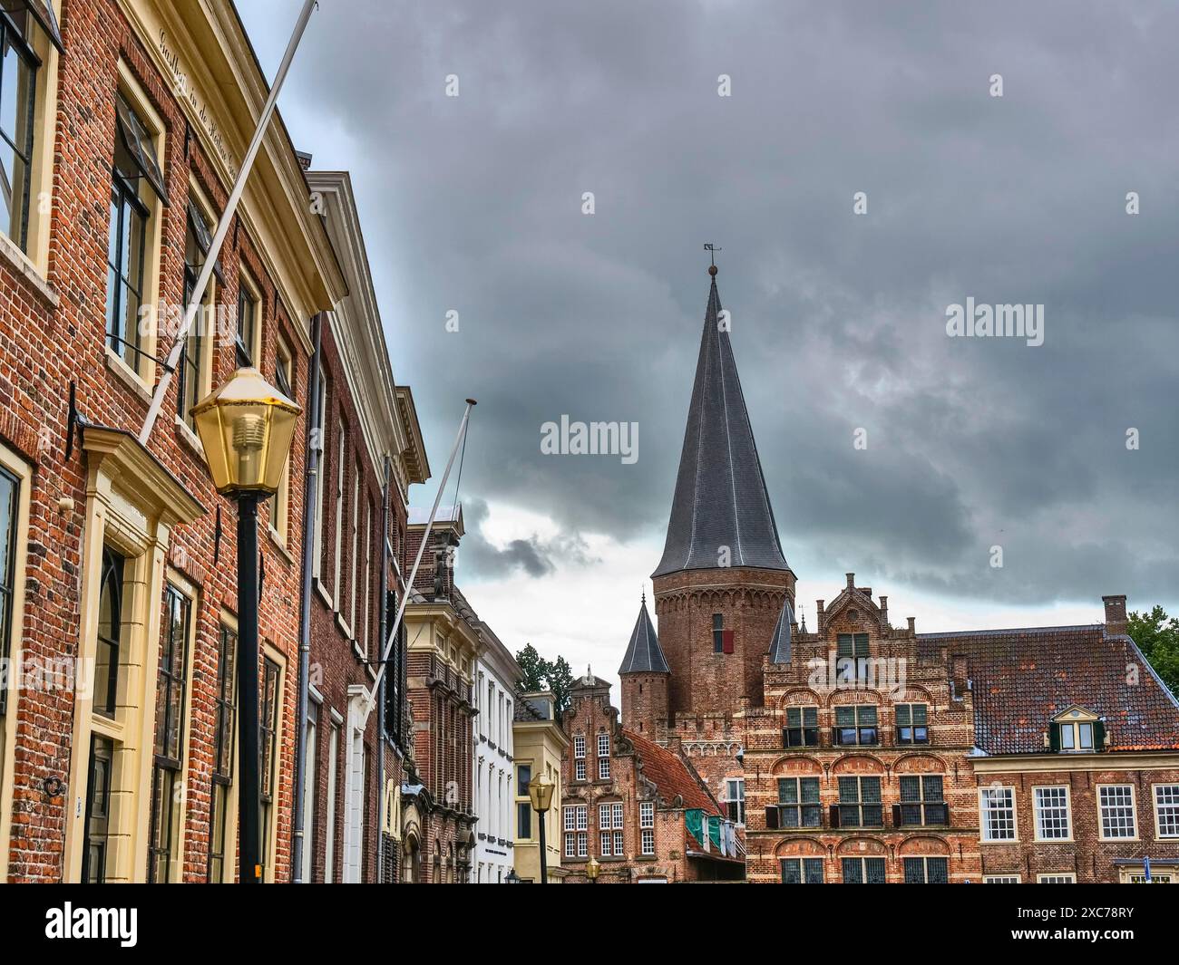 Historic street with a church spire and surrounding brick buildings ...