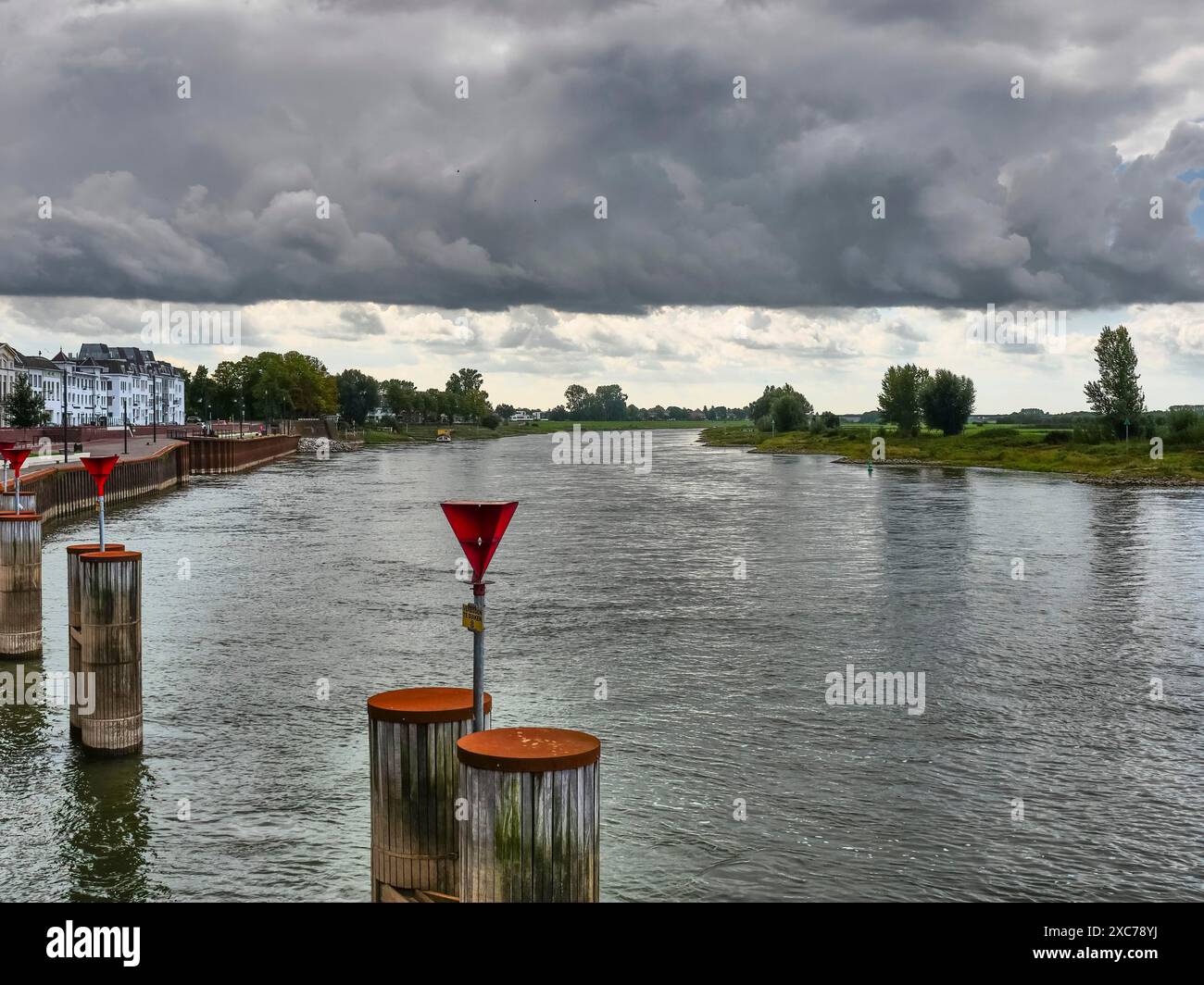 Wide river with deep clouds above, surrounded by a calm autumnal ...