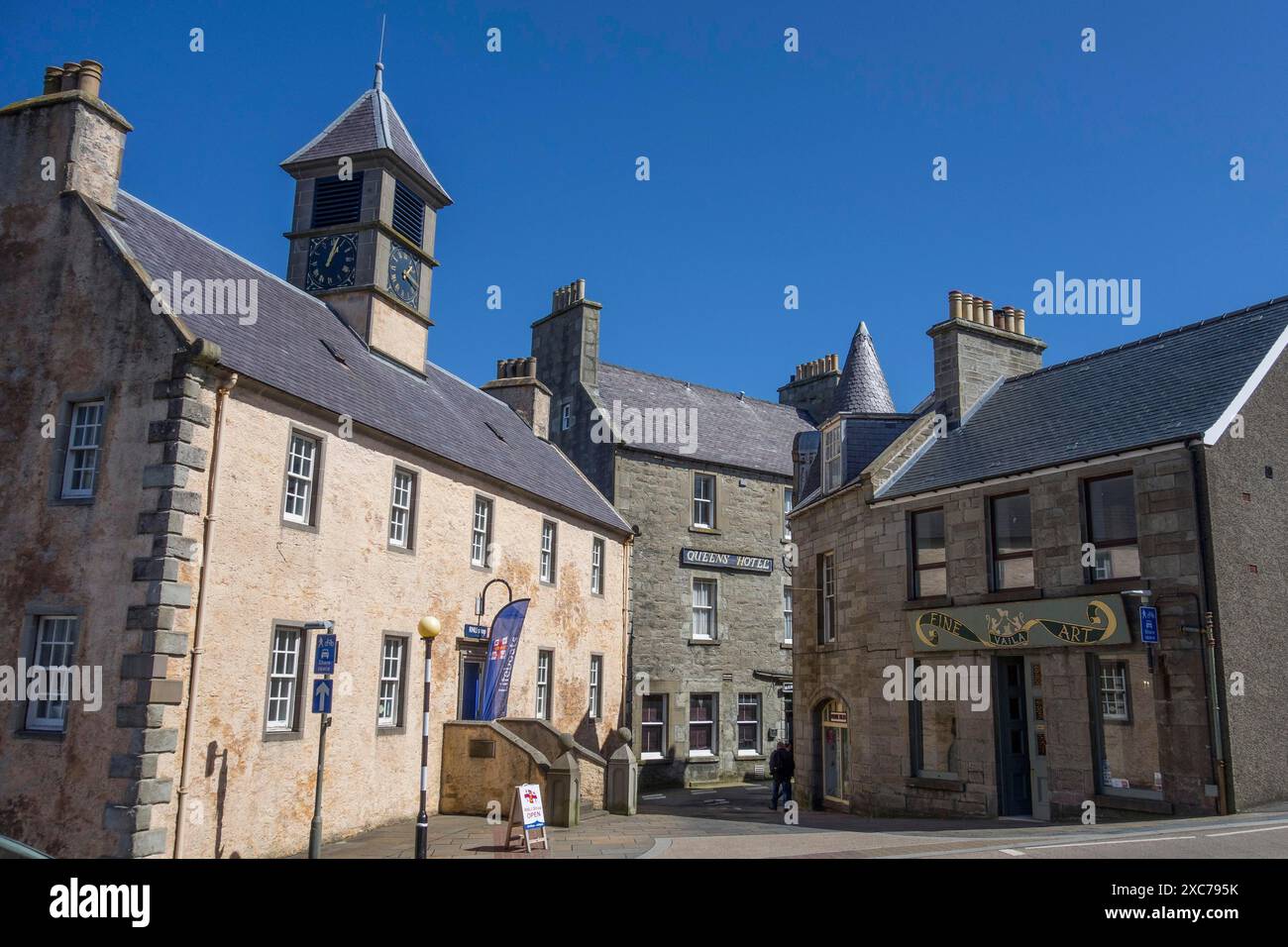 Historic buildings with a clock tower under a blue sky in a small ...