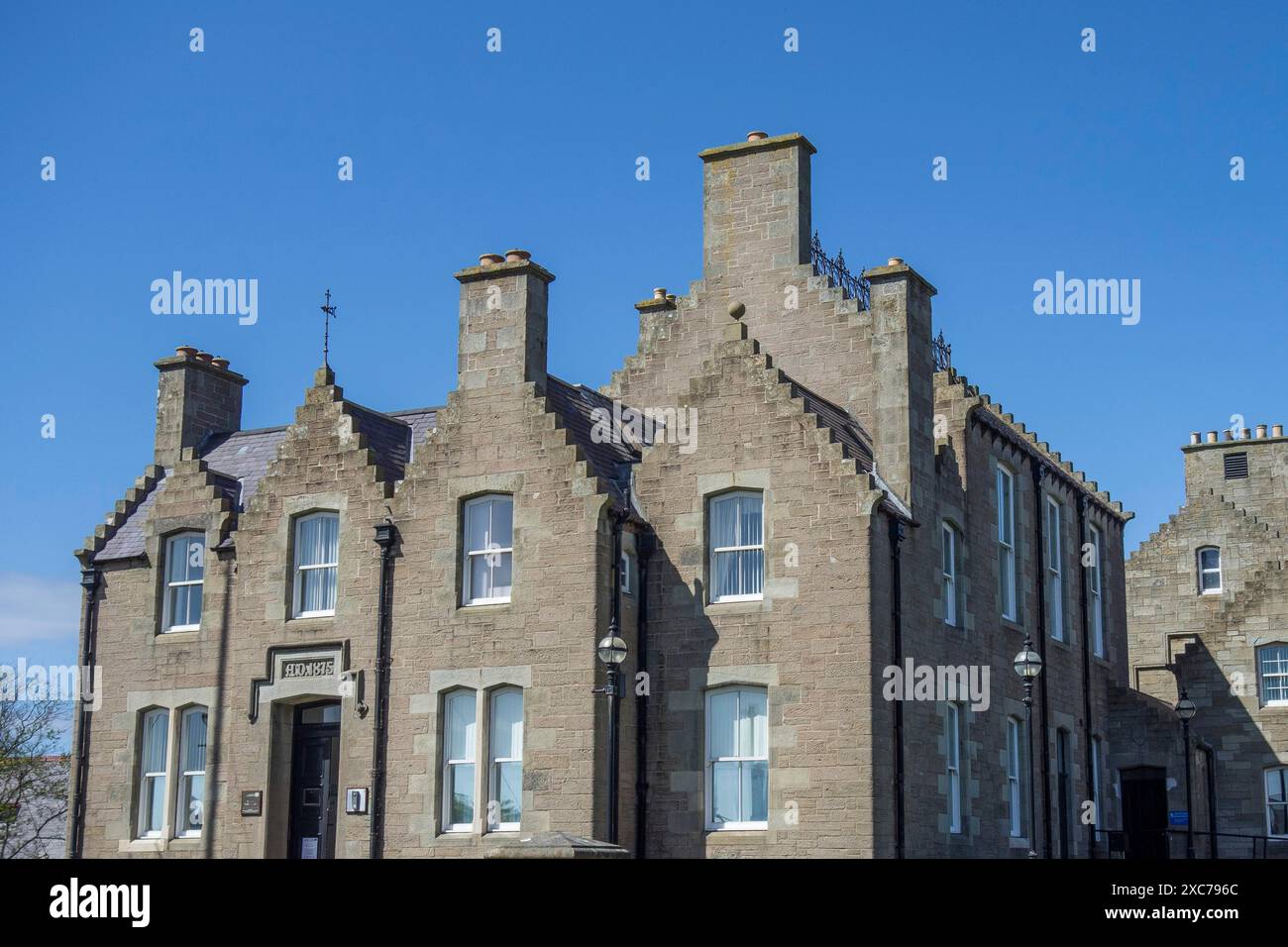 Historic stone building with multiple chimneys and a clear structure ...