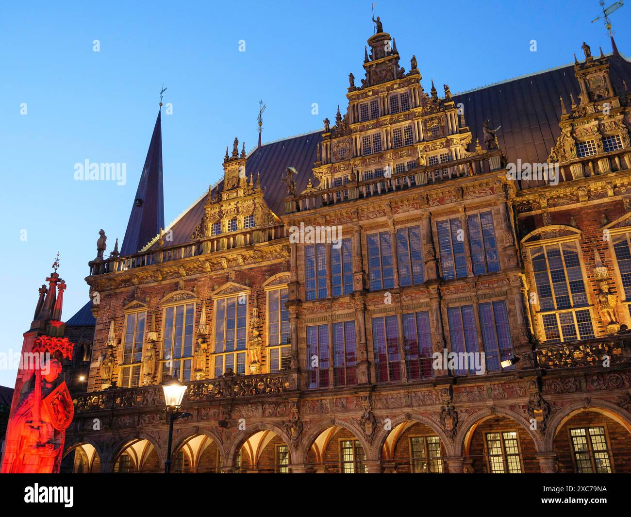 Illuminated facade of a historic building with elaborate reliefs and ...