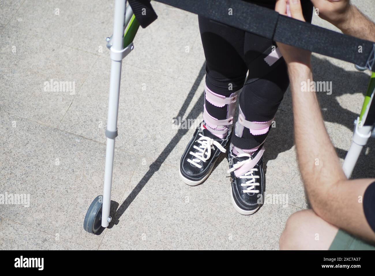 child with walking frame and knee orthosis outdoor Stock Photo - Alamy