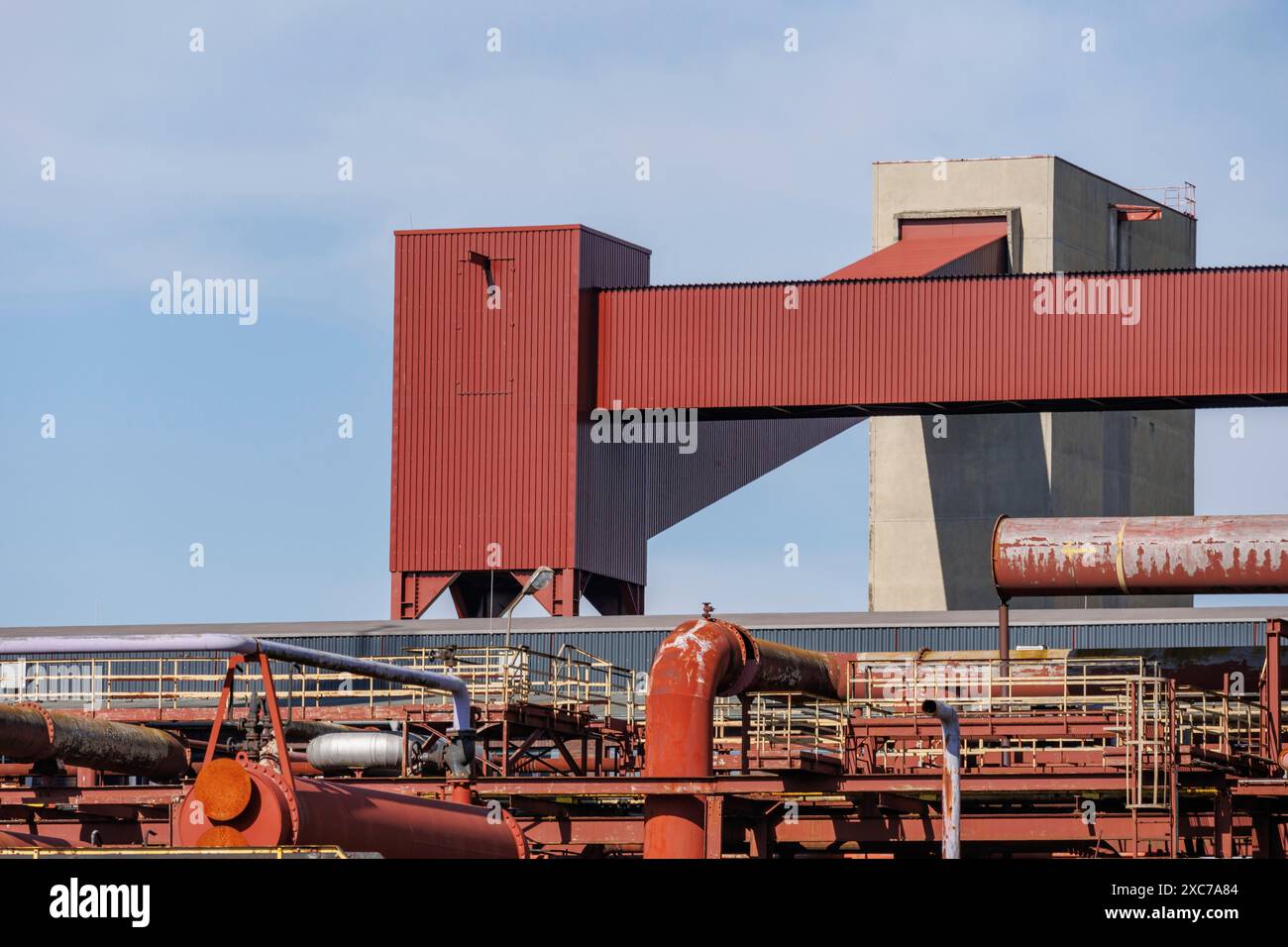 Red and beige industrial buildings with pipes and structural complex ...