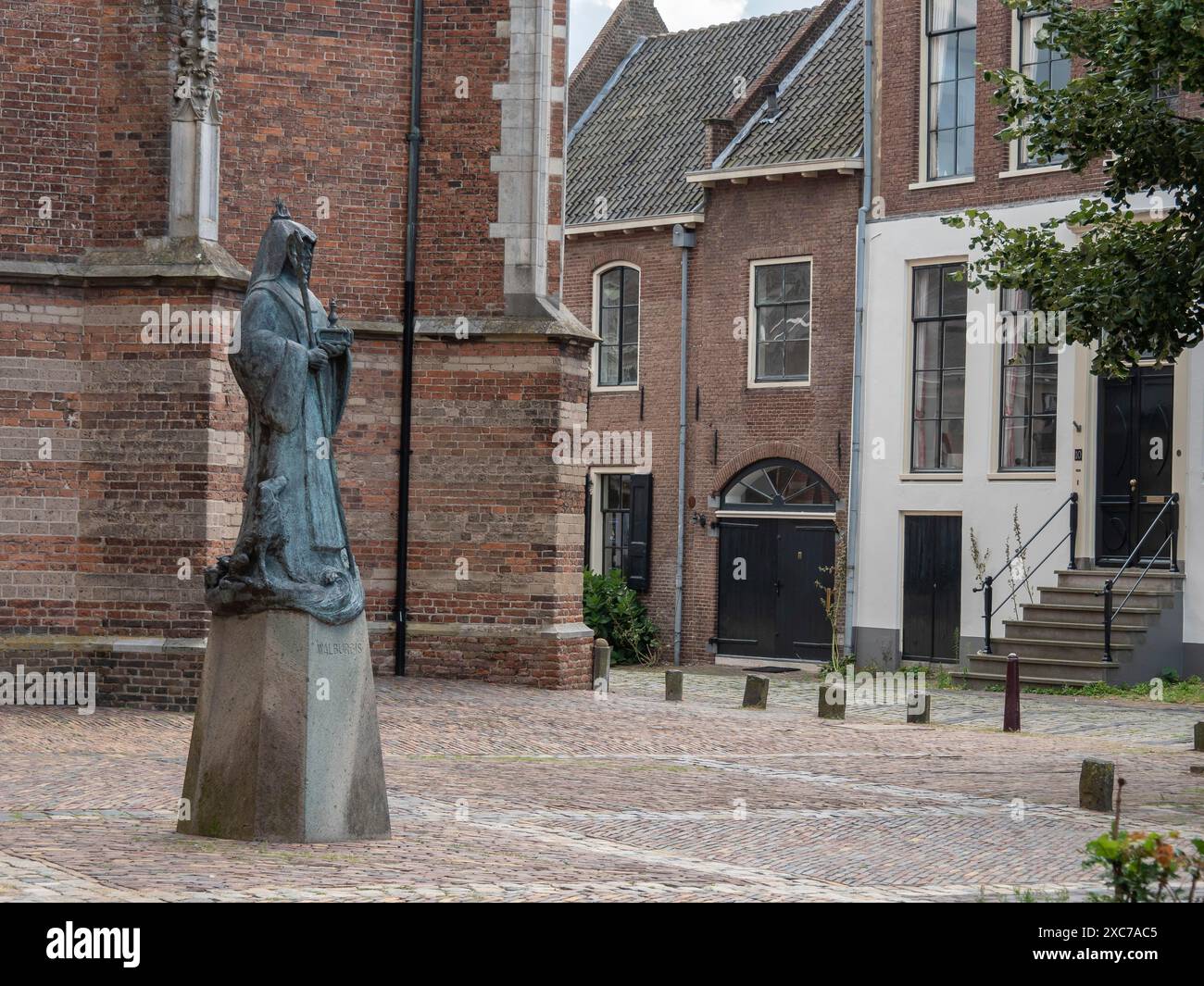 Inner courtyard with a bronze statue in front of a historic building ...