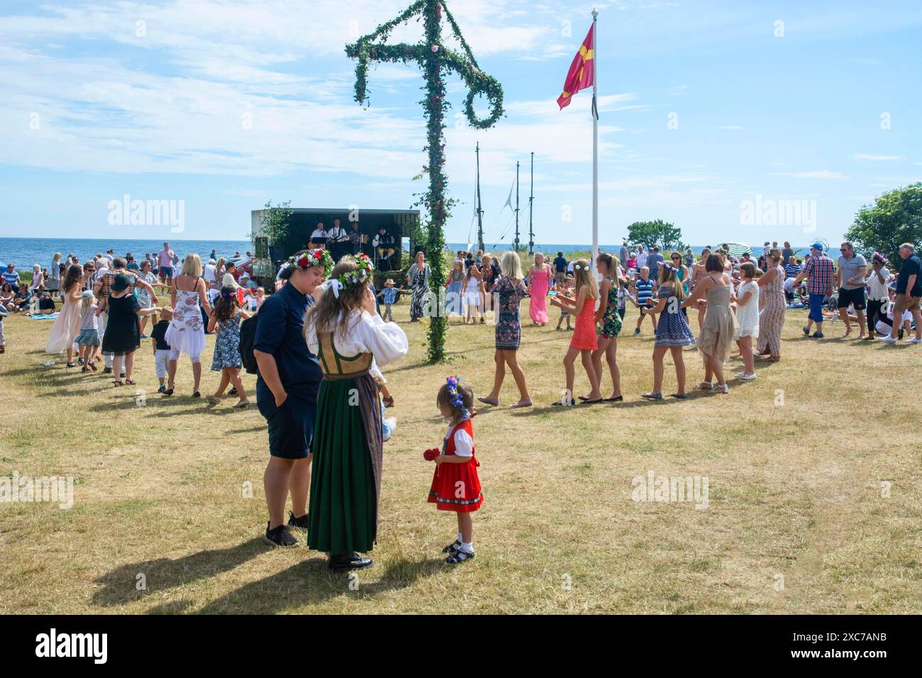 Traditional midsummer celebration with dancing around the maypole at ...