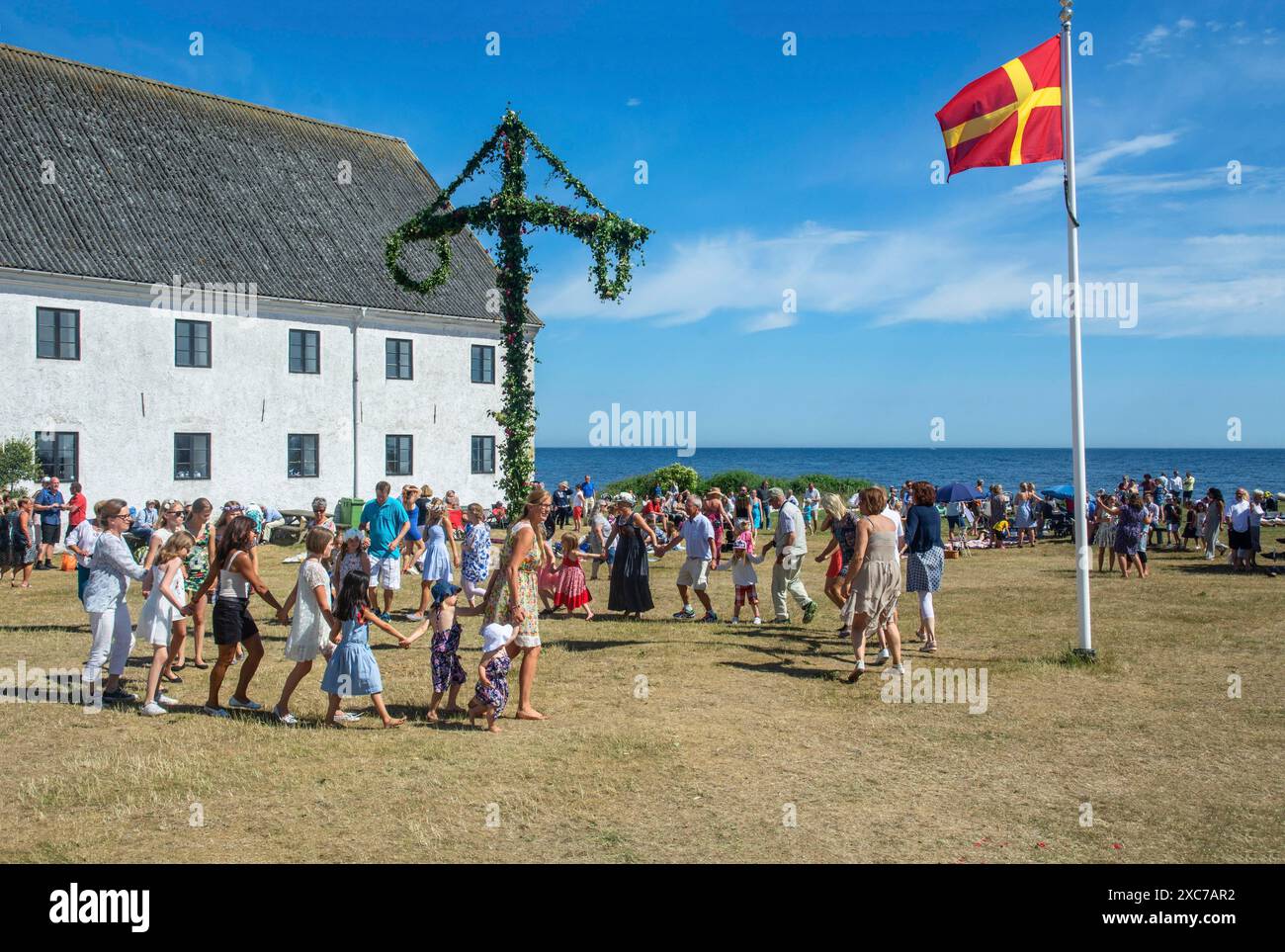 Traditional midsummer celebration with dancing around the maypole at ...