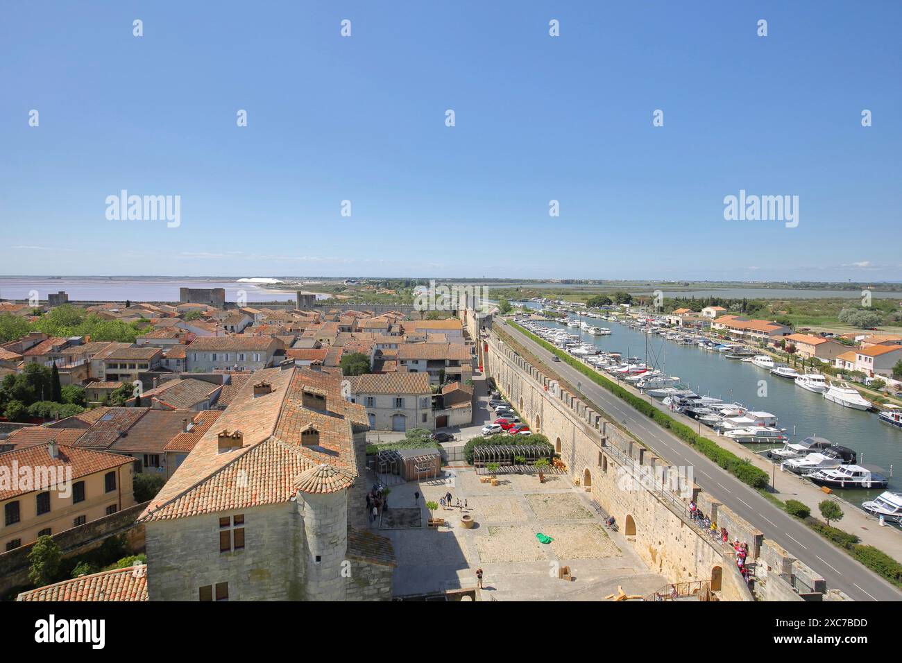 View of marina with yachts and Etang de la Marette, salt lake ...