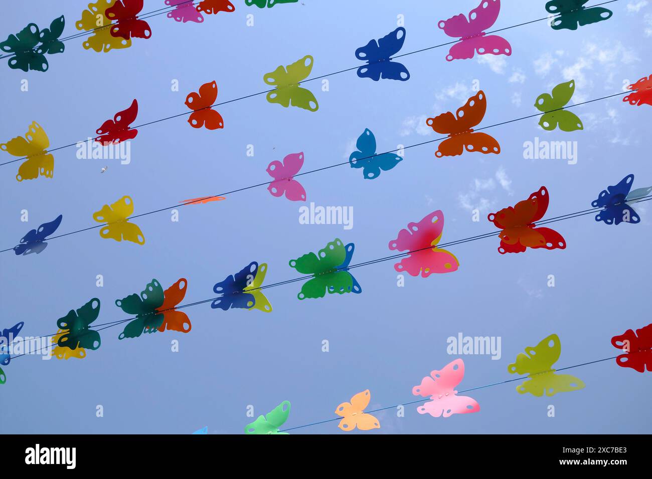 Butterfly figures as colourful decoration on ropes, pennant chain ...