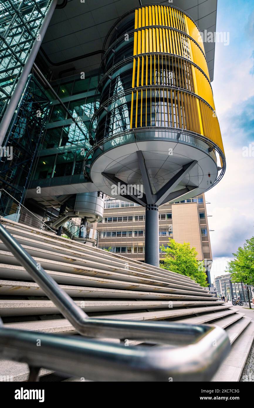 Modern building design with glass facade and yellow blinds in an urban ...