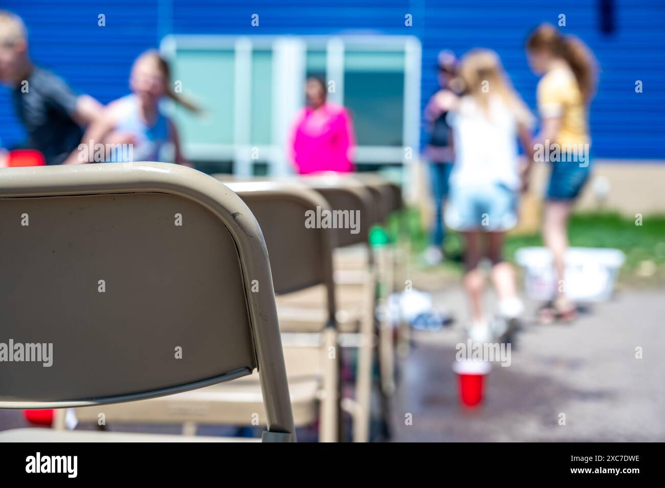 Selective focus on the back of a metal folding chair with blurred ...