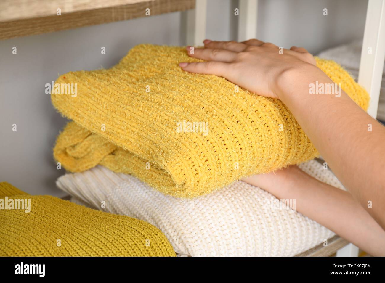 Woman putting clean clothes hi-res stock photography and images - Alamy
