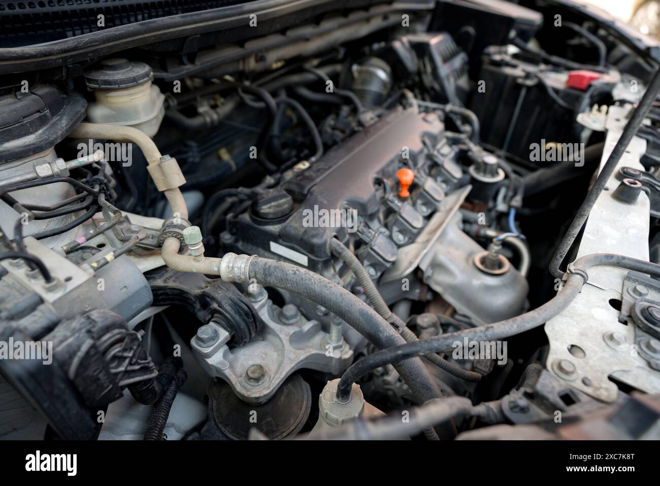 Closeup view of a car engine with various component and wire visible ...