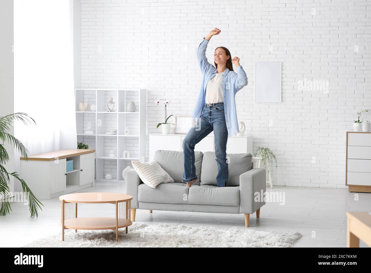 Woman dancing on couch hi-res stock photography and images - Alamy