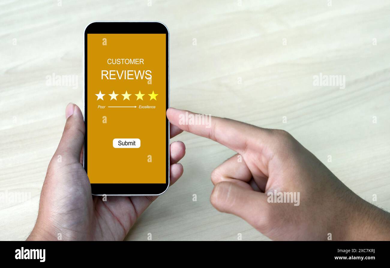 Closeup hand holding a smartphone. The phone's screen show a five star ...