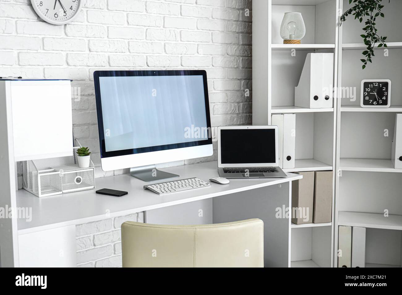 Interior of light office with modern workplace and shelf unit Stock ...
