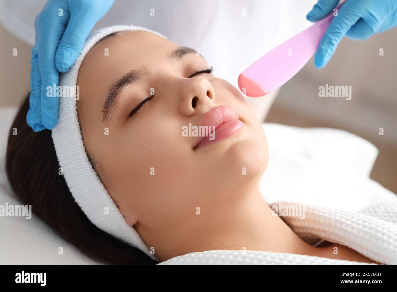 Beautician removing woman's hair on cheek with wax in salon, closeup Stock Photo - Alamy