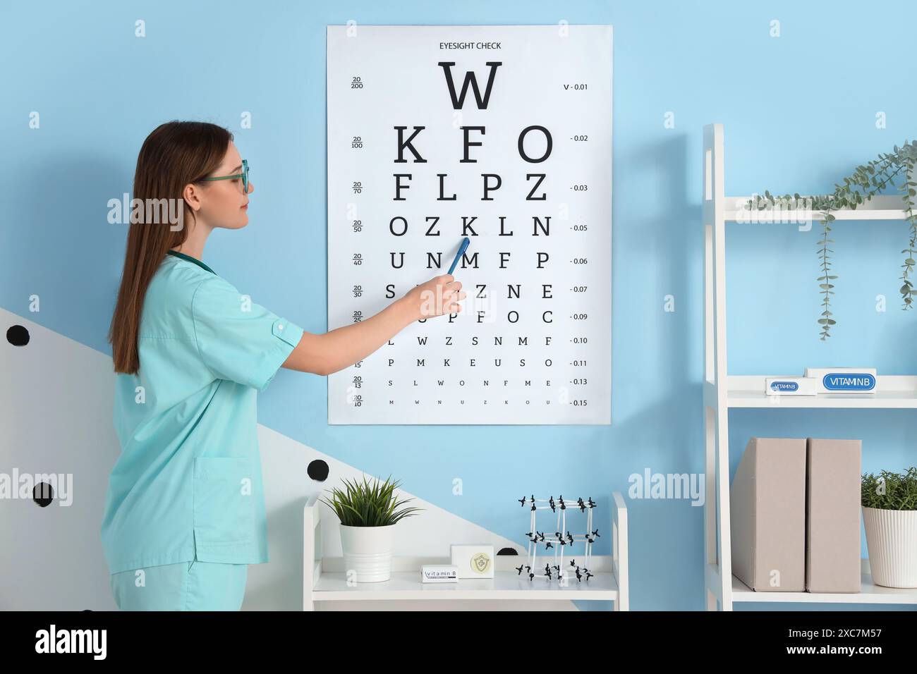 Female ophthalmologist near eye test chart in clinic Stock Photo - Alamy