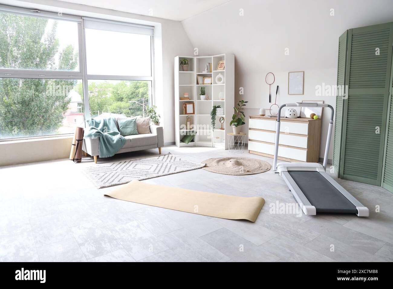 Interior of gym with sports equipment, sofa and drawers Stock Photo - Alamy