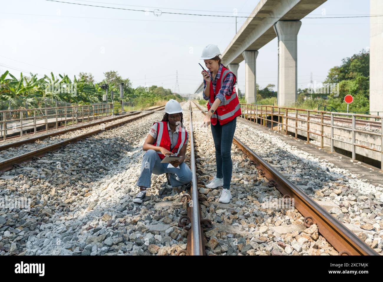 Rail transportation engineer in safety vest and hardhat check the ...