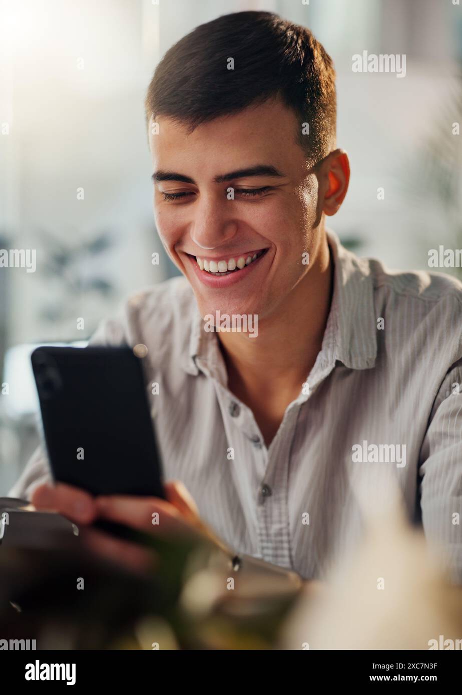 Joke, laugh and happy man on smartphone for social media, message and ...