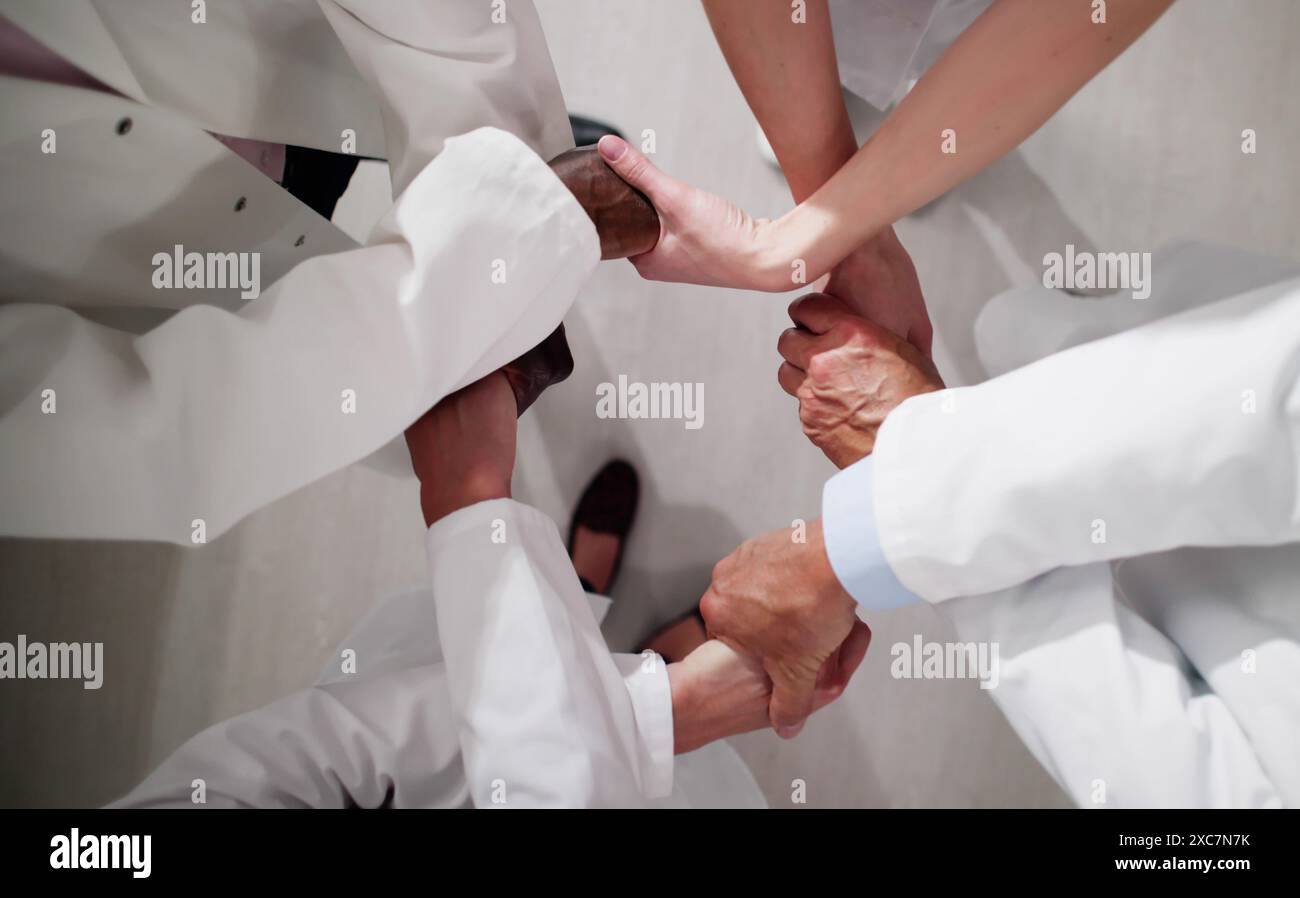 Multiracial nurse holding hands hi-res stock photography and images - Alamy