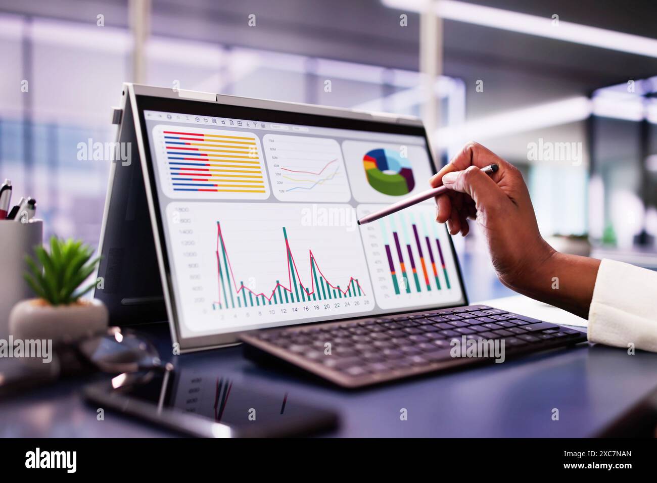 African American woman analyzing financial data on laptop screen in ...