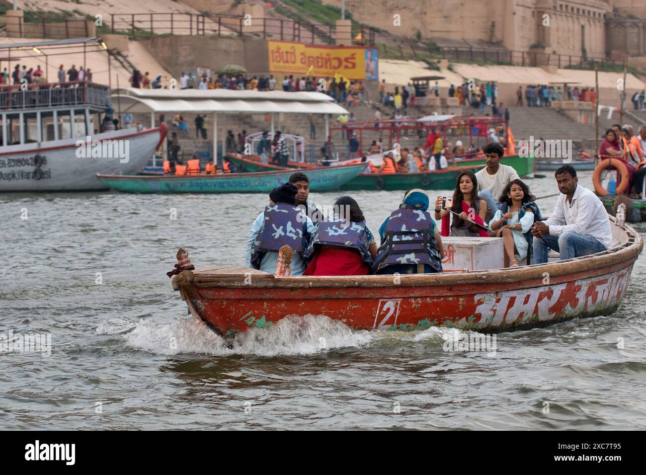 Varanasi, India: pilgrim boats on the river. Varanasi is one of the ...