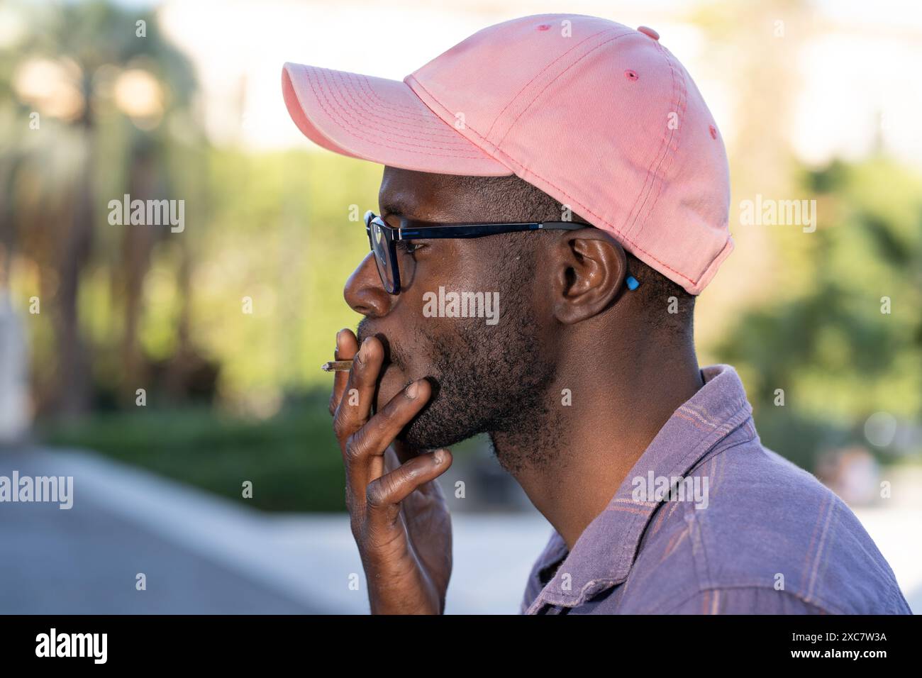 Profile young man smoking cigarette hi-res stock photography and images ...