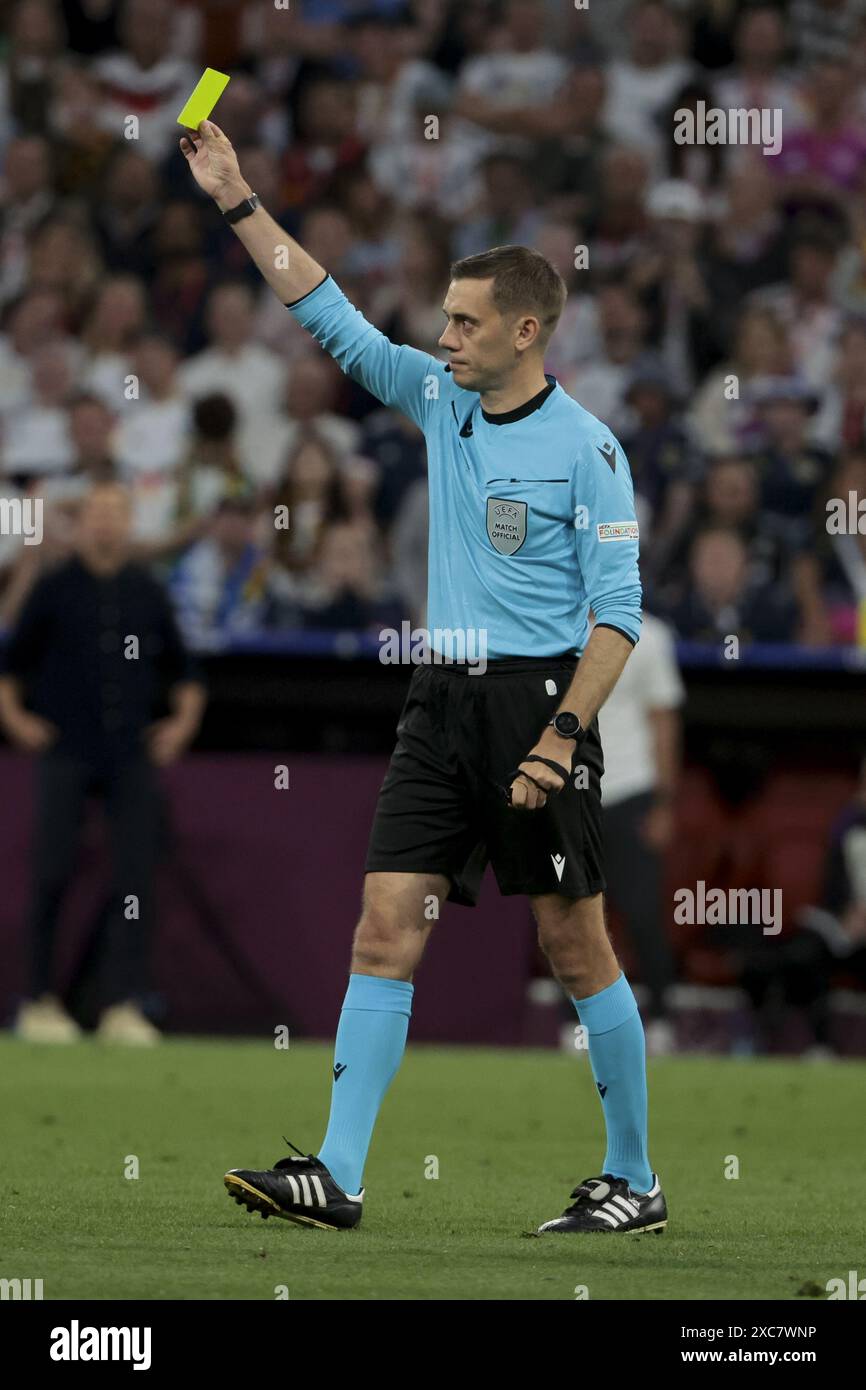 Referee Clement Turpin gives a yellow card during the UEFA Euro 2024 ...