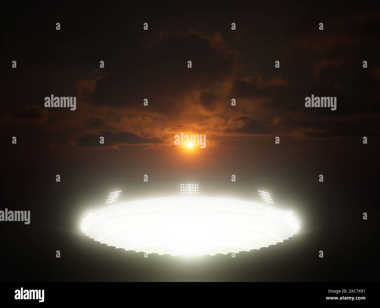 A football stadium illuminated by an array of spotlights in the night ...