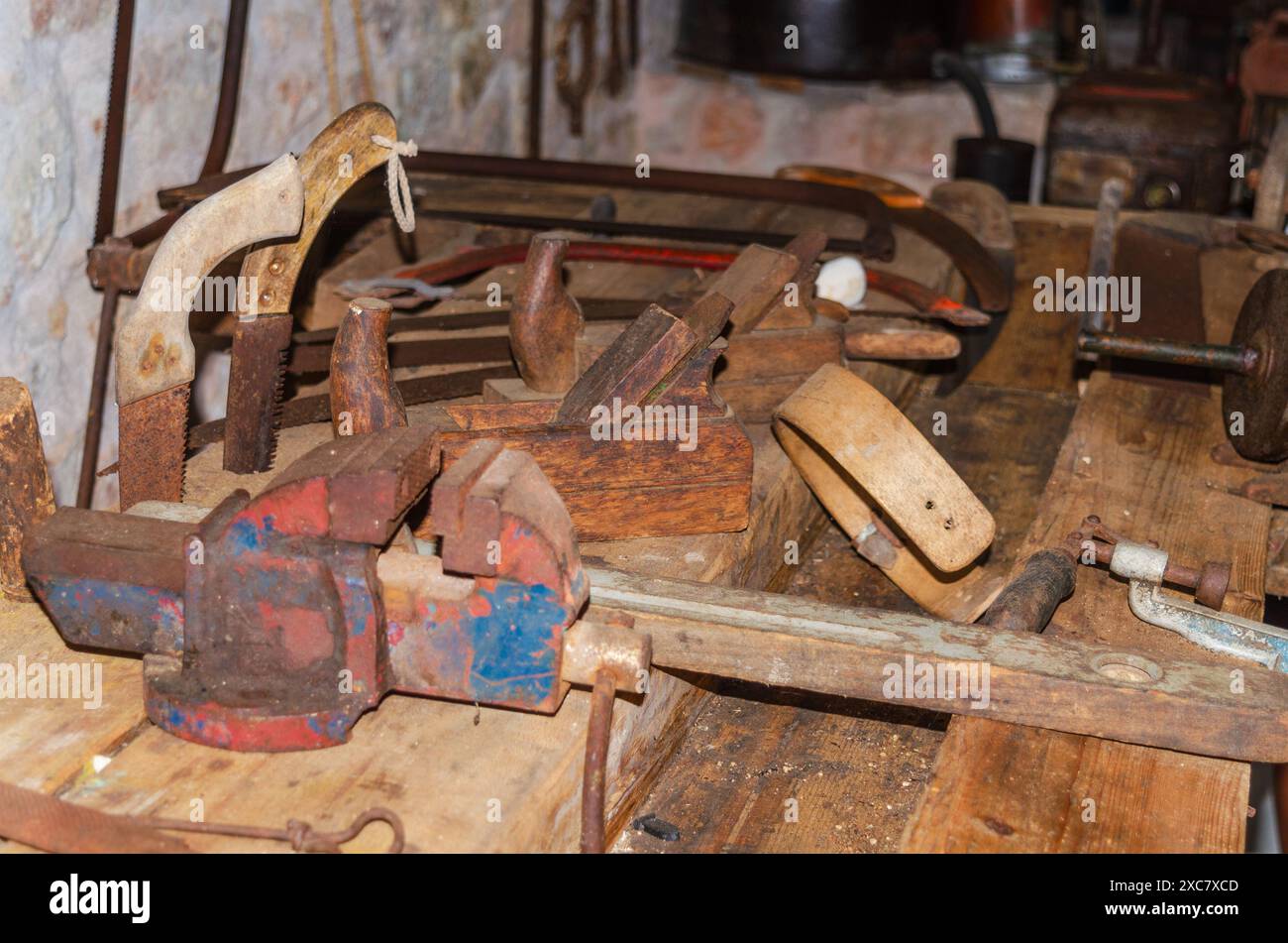 Old rusty tools lying on a wooden work bench Stock Photo - Alamy