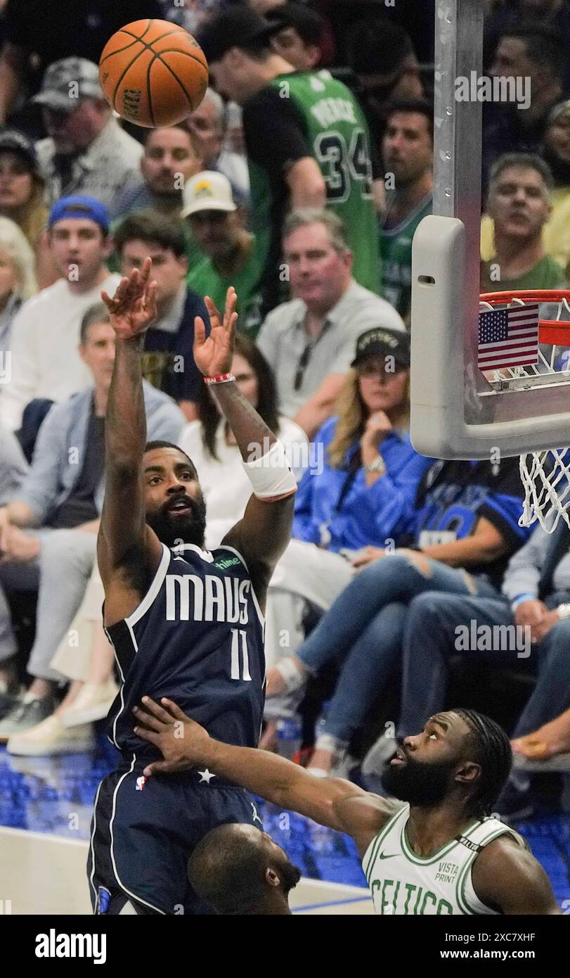 Dallas, USA. 14th June, 2024. Dallas Mavericks' Kyrie Irving (L) shoots ...