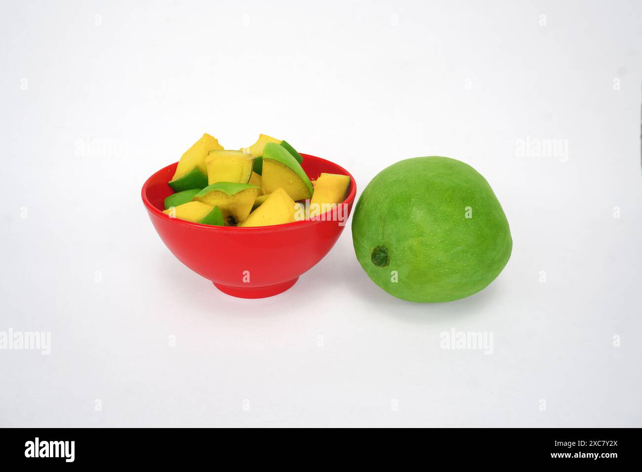 Mangos Slices in red bowl with one mango, isolated on white background ...