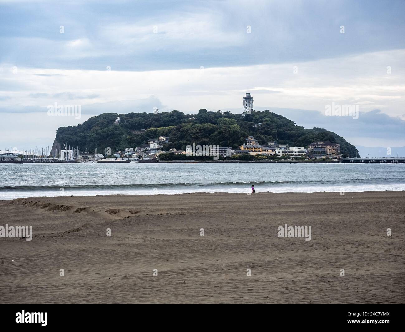 Enoshima island seen across Katase Beach in Fujisawa, Japan in early ...