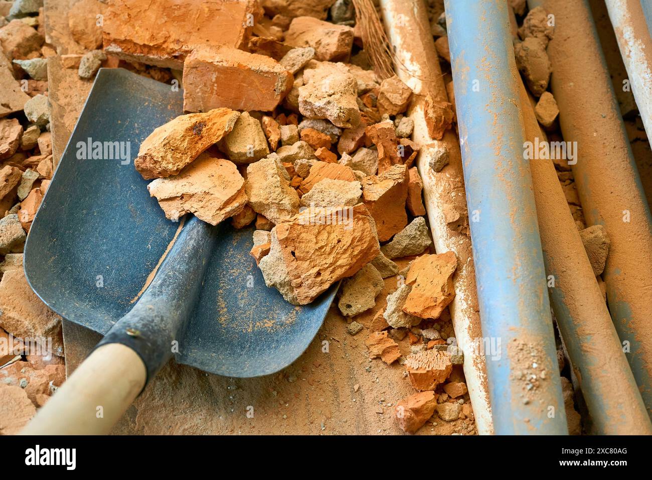 Scoop shovel on garbage broken brick collection at construction site ...