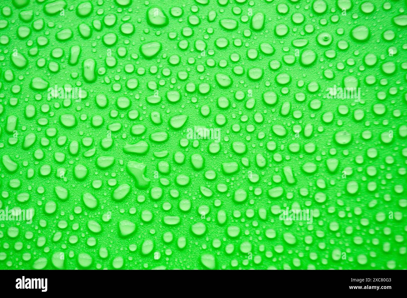 Top view of water droplets on green background Stock Photo - Alamy