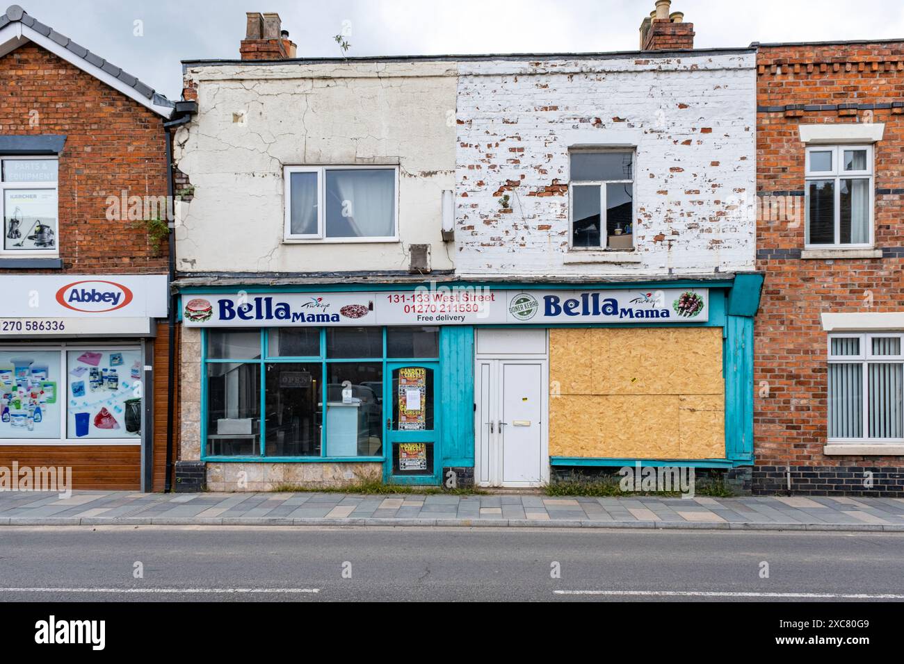 Closed down and boarded up Bella Mama takeaway in Crewe Cheshire UK ...