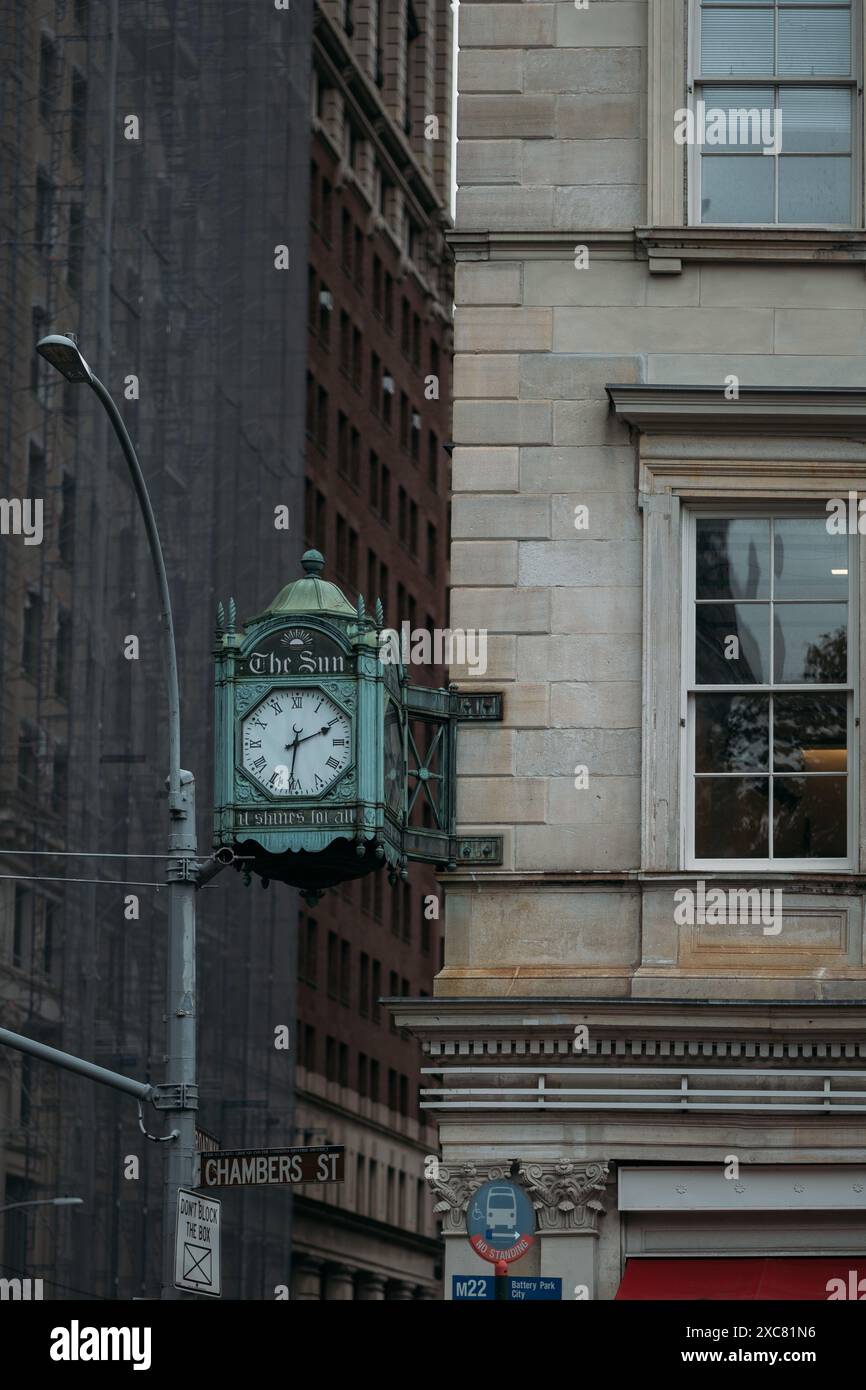 Historic clock on building corner in downtown New York City with street ...