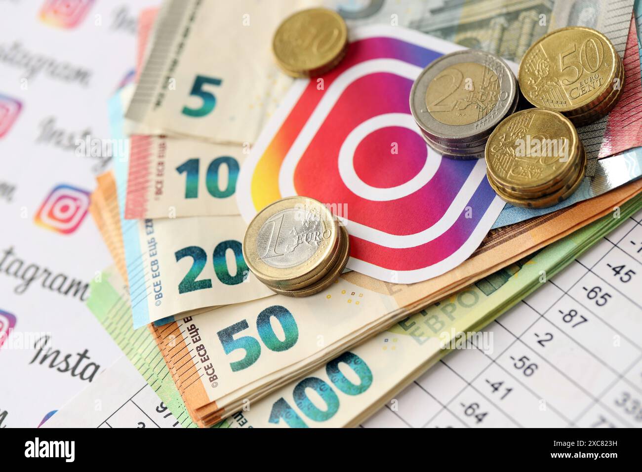KYIV, UKRAINE - APRIL 20, 2024 Instagram logo and many euro money bills ...