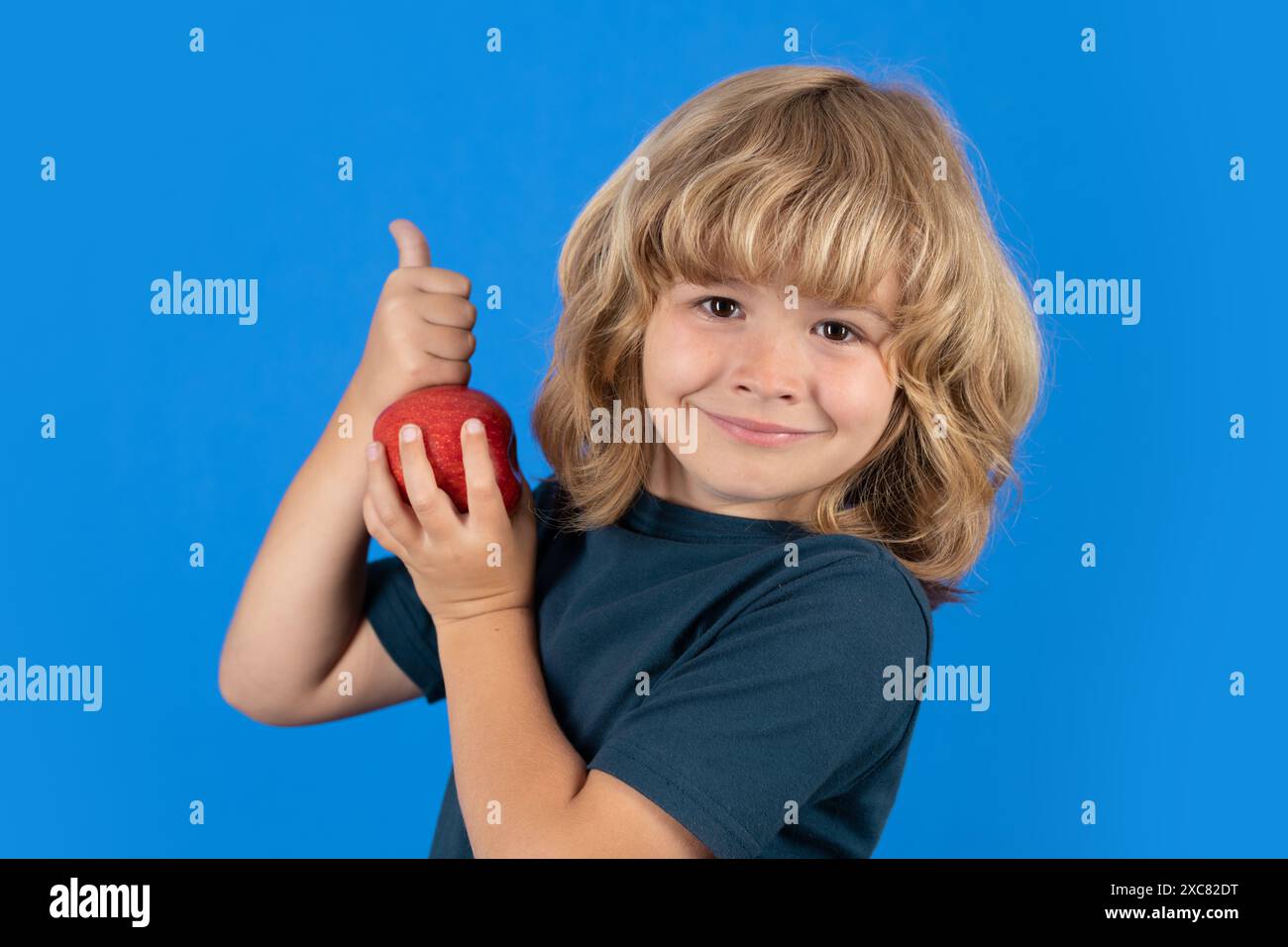 Healthy eating. Portrait of cute child boy holding fresh red apple ...