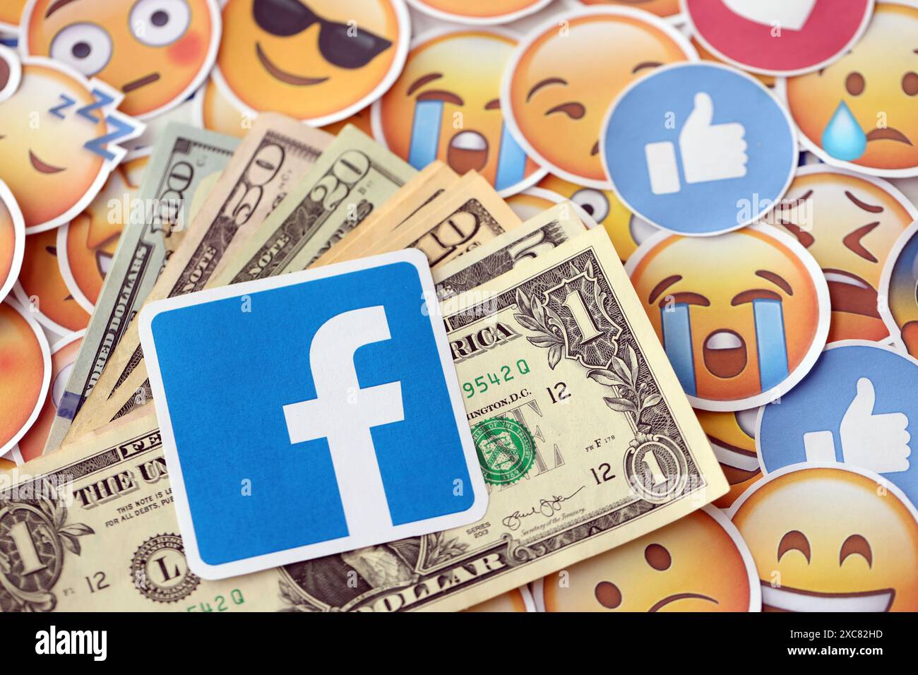 KYIV, UKRAINE - APRIL 20, 2024 Facebook logo and many usd money bills ...